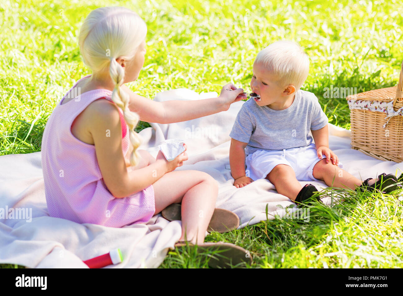 Responsible sister taking care about her small brother Stock Photo - Alamy