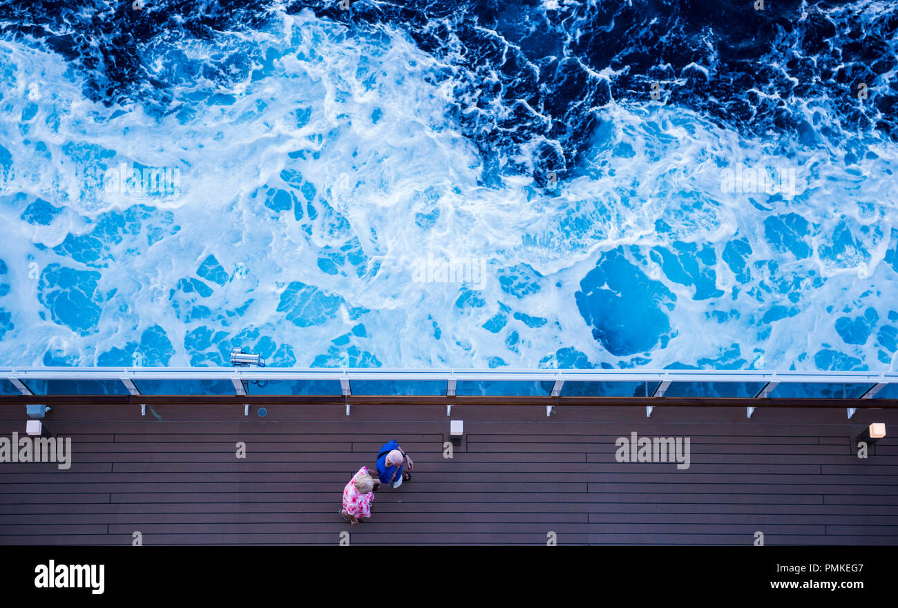 Man and woman walking along bridge of cruise ship MSC Seaview ...