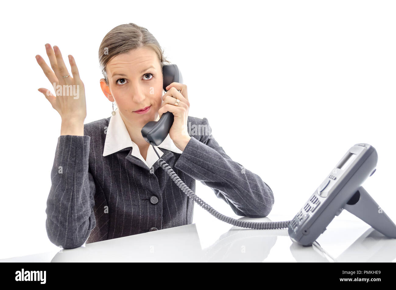 Impatient business woman at white desk making a phone call Stock Photo ...