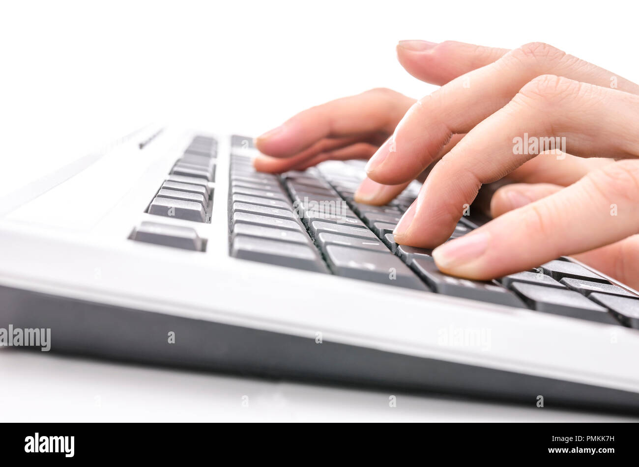 Side view of hands typing on keyboard. Isolated over white background ...