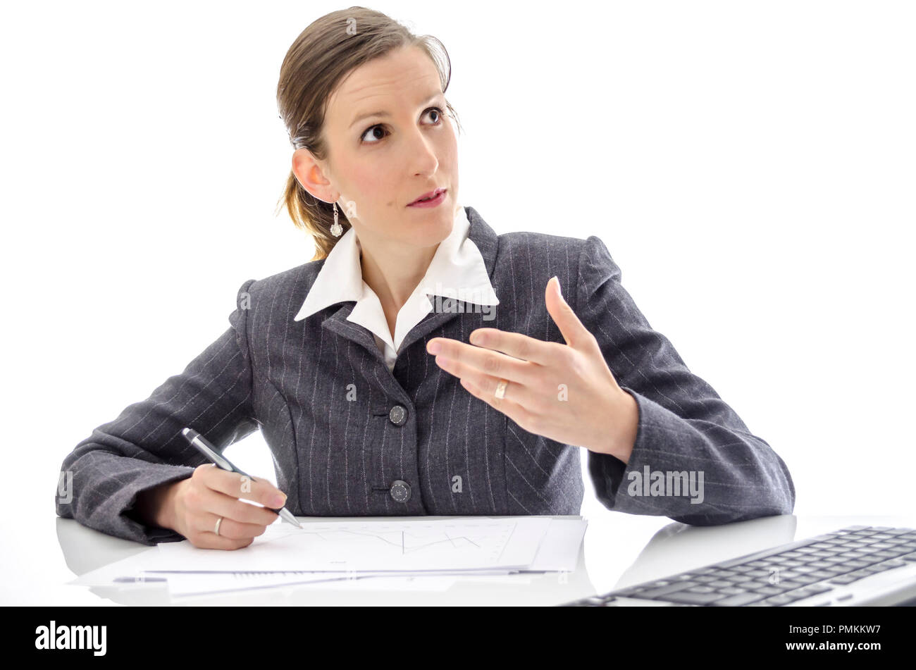 Business woman explaining something at office desk. Isolated over white ...
