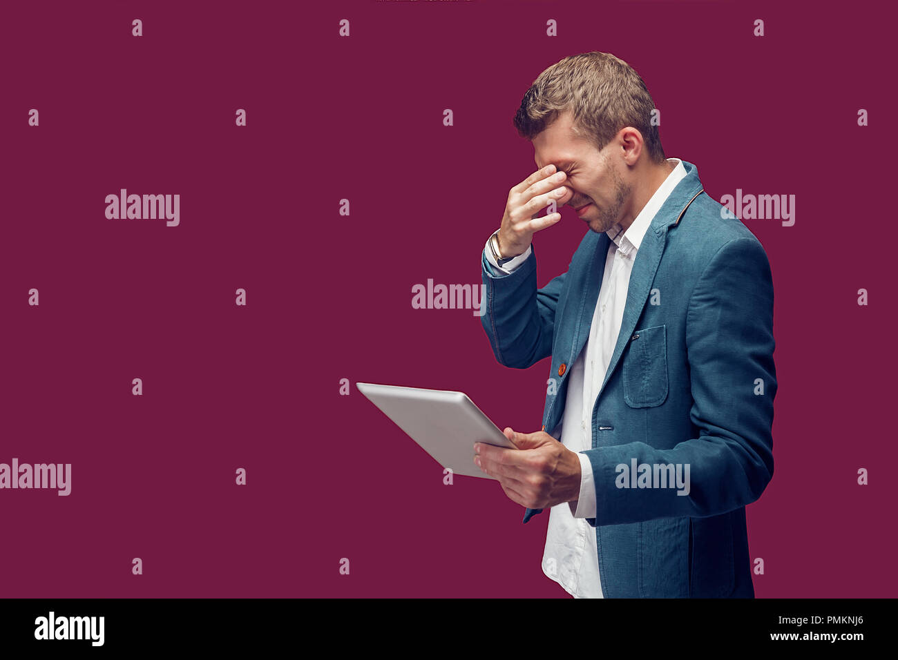 Disappointed man holding tablet and closed eyes with hand. Horizontal ...