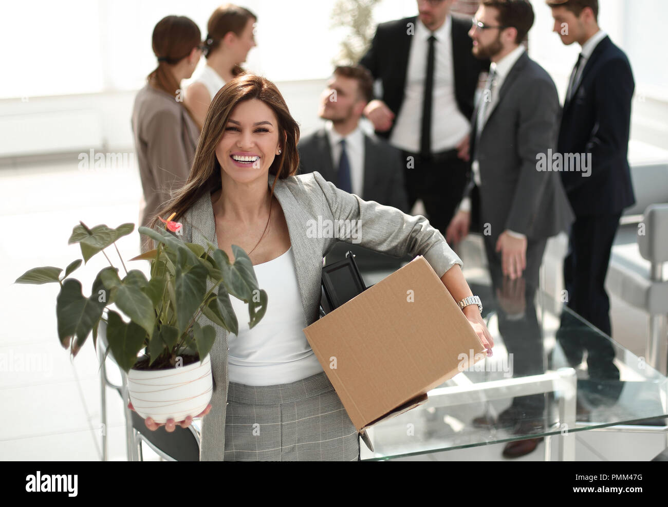 Young happy business woman with boxes for moving into a new office ...