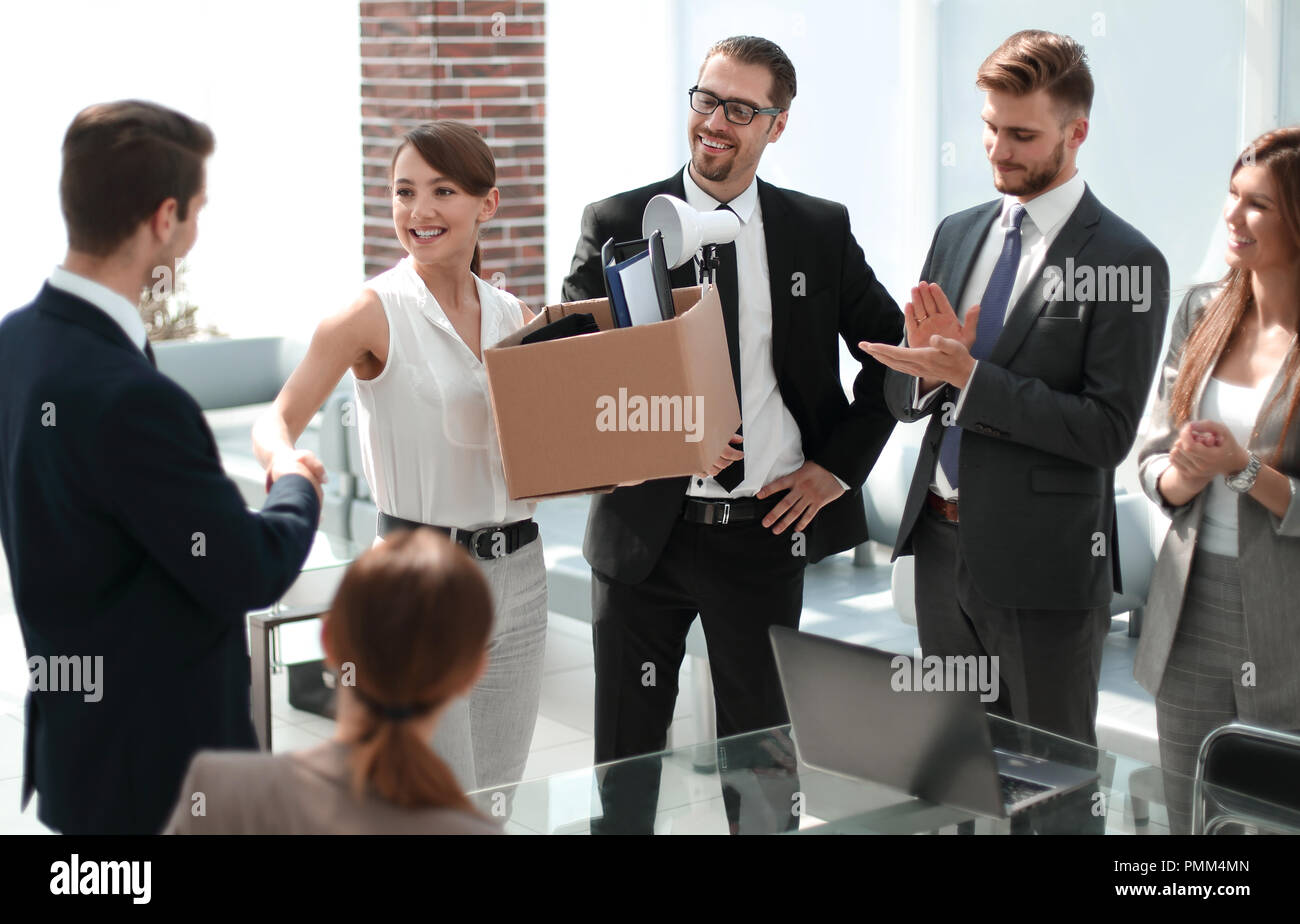 young employee shaking hands with a business colleague in the workplace ...