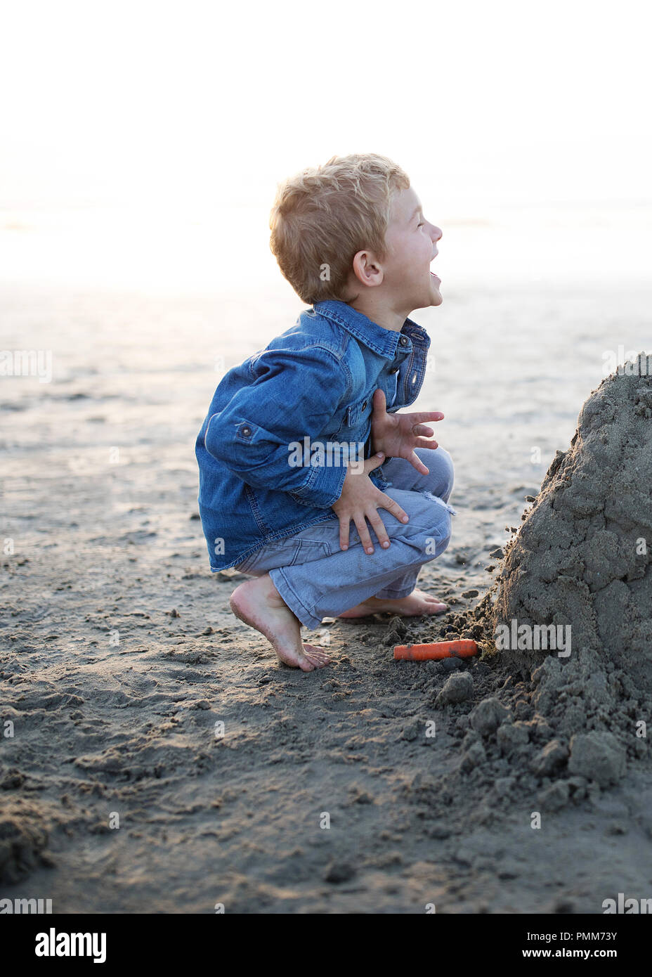Boy building sandcastle on beach hi-res stock photography and images ...
