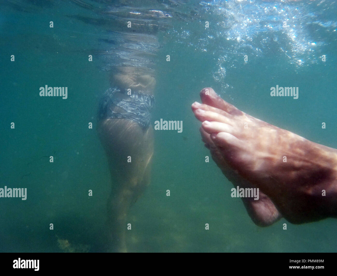 Two people swimming underwater, Apulia, Italy Stock Photo - Alamy