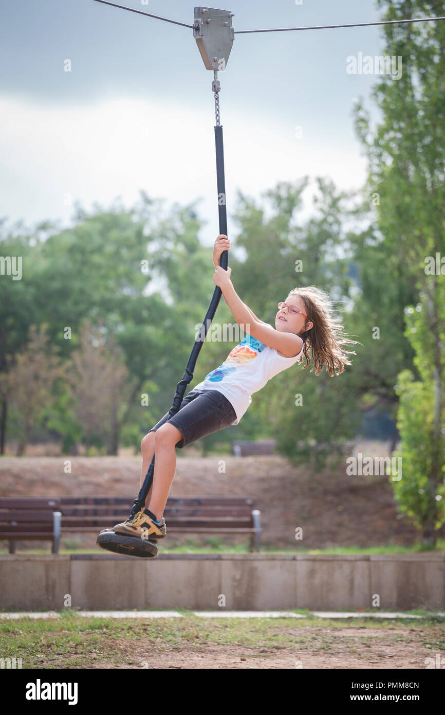 Boy on a zip-line in a park, Spain Stock Photo - Alamy