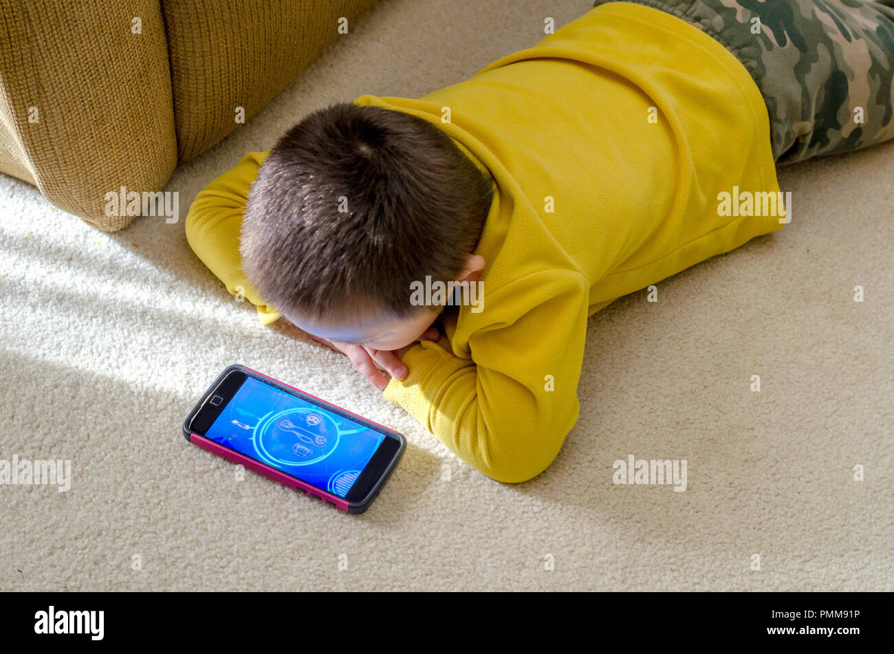 watching cartoons on moms cell phone Stock Photo - Alamy