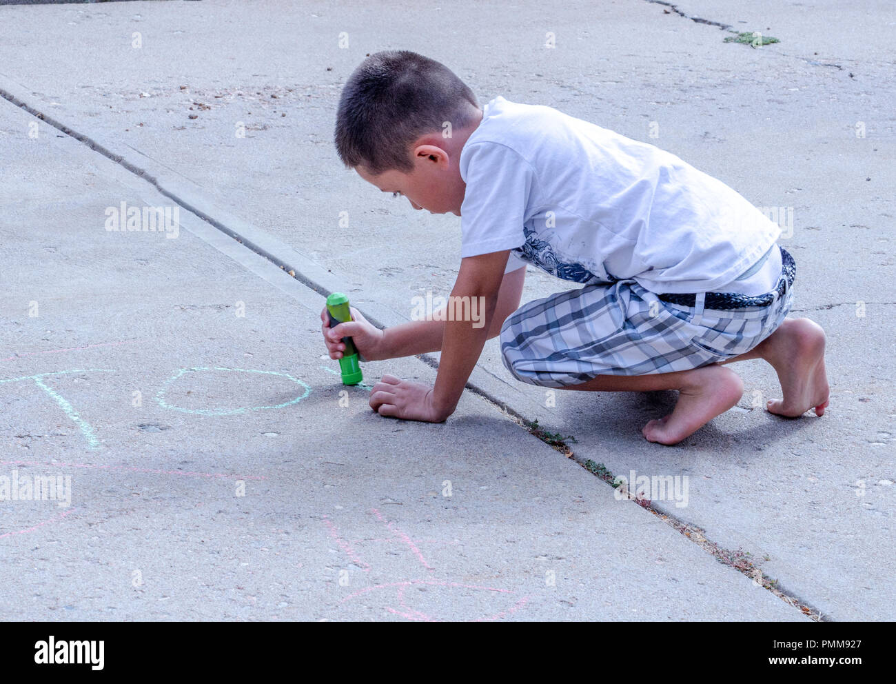 Writing letters on the cement with chalk Stock Photo - Alamy