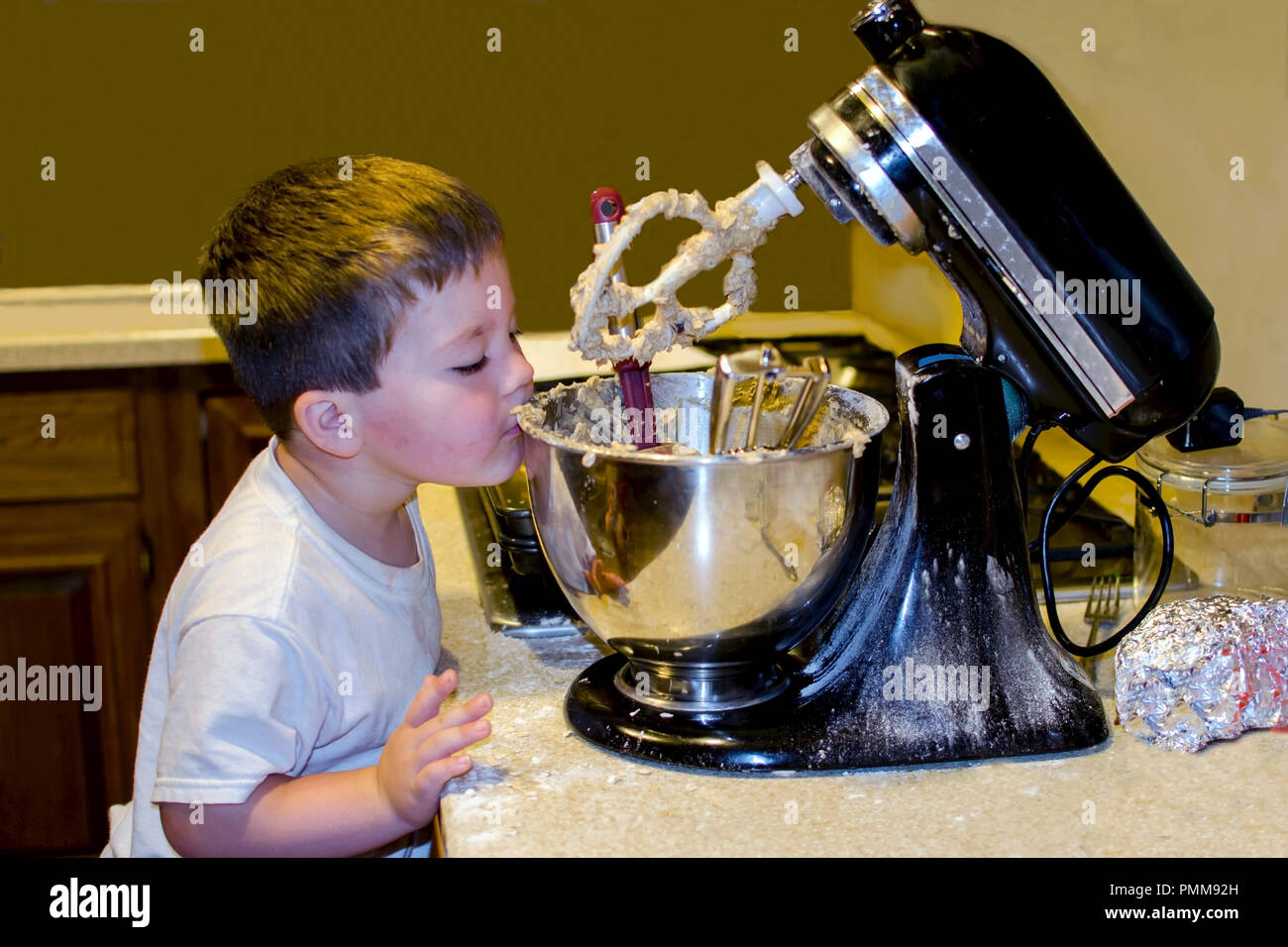 Boy mixing chocolate in kitchen hi-res stock photography and images - Alamy