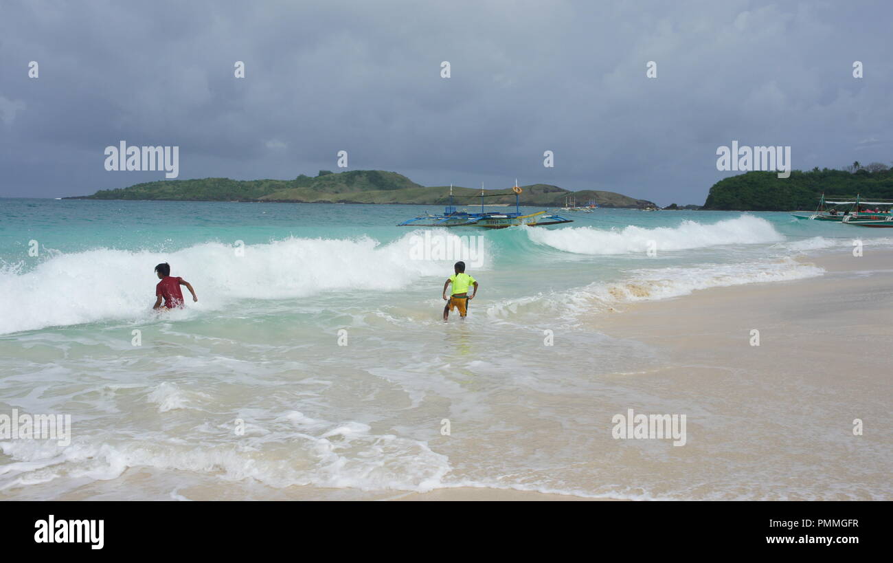 Little Kids Playing With The Beach Waves Along The Seashore Stock Photo ...
