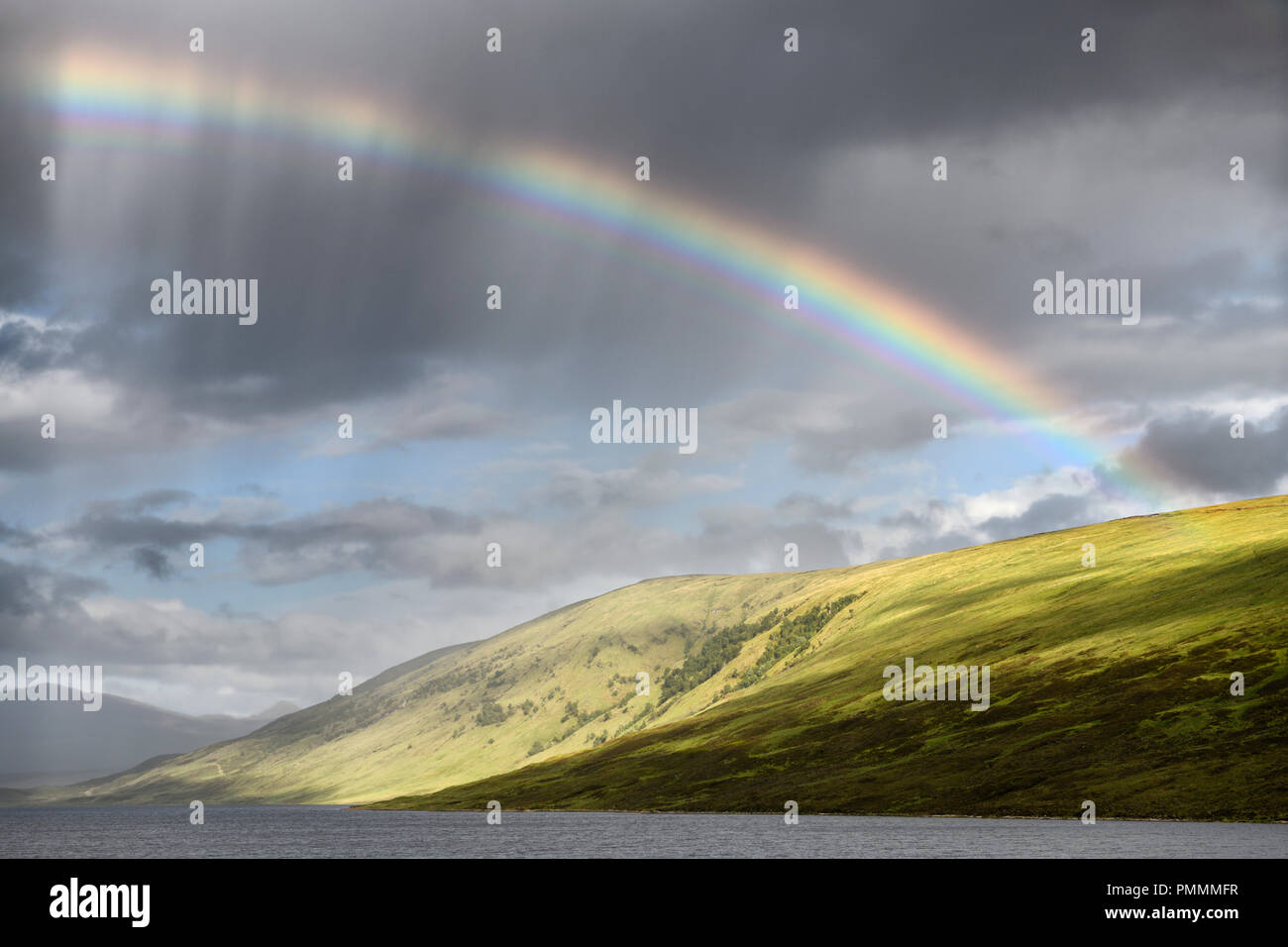 Rainbow and dark clouds over Loch a Chroisg ending at An Liathanach ...