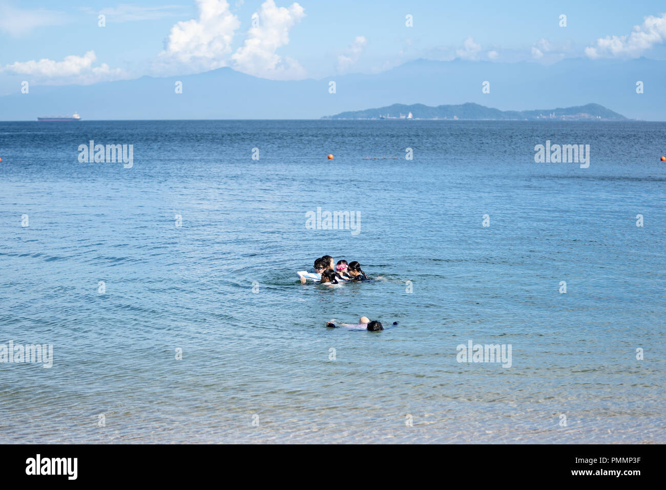 Girls Swimming in Beach Stock Photo - Alamy