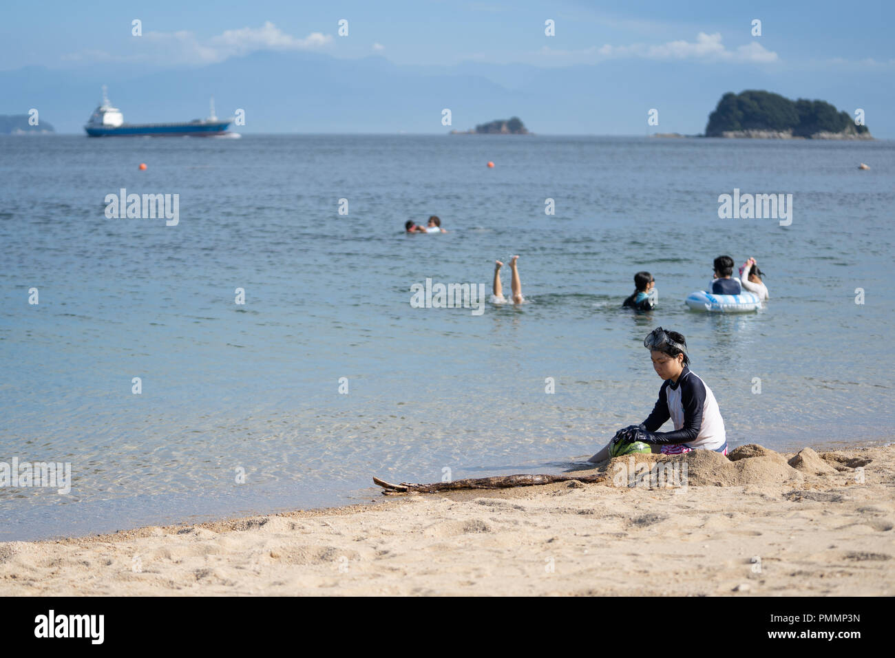 Girls Swimming in Beach Stock Photo - Alamy
