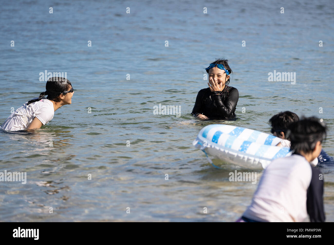 Girls Swimming in Beach Stock Photo - Alamy