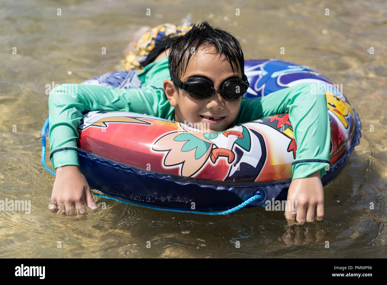 Boy Swimming in Beach Stock Photo - Alamy
