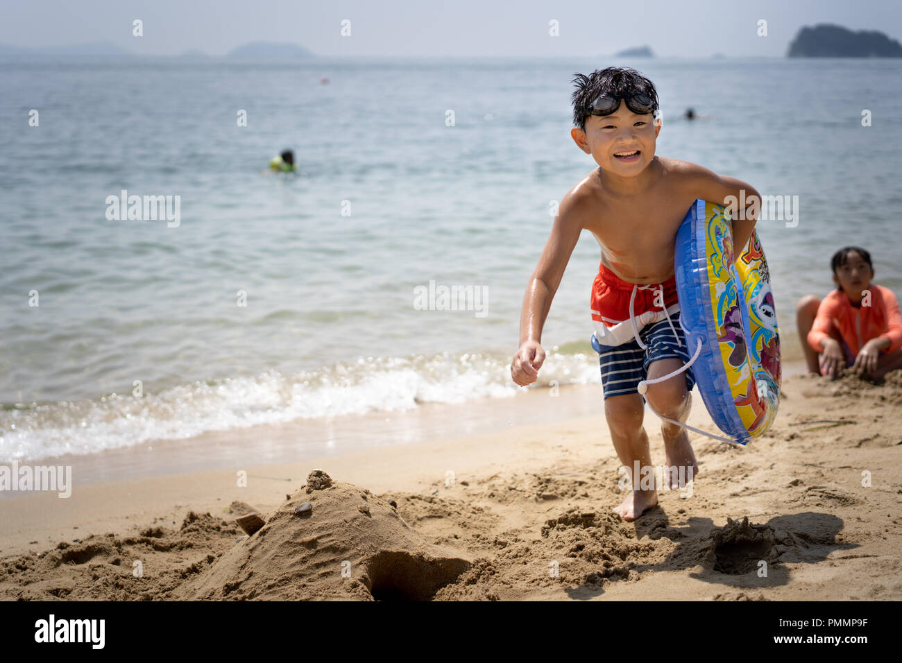 Boy Swimming in Beach Stock Photo - Alamy