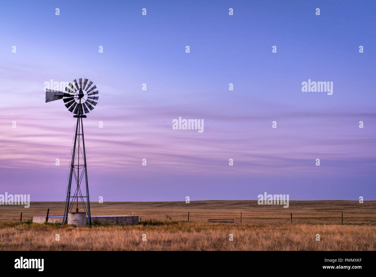 windmill with a pump and cattle water tank in shortgrass prairie ...