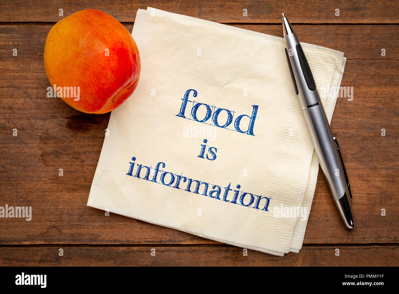 Food is information - handwriting on a napkin with a fresh apricot ...