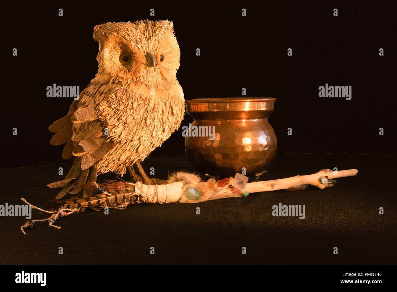 Copper cauldron, a magic wand with quartz and amethyst crystals and an ...