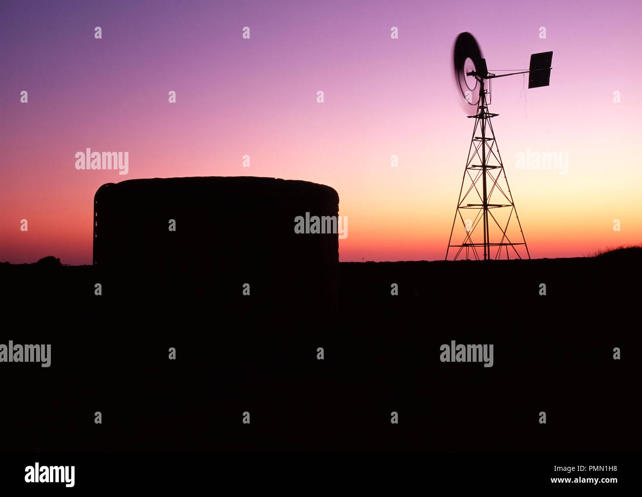 Windmill and water tank at Dusk in Australian outback, Western ...