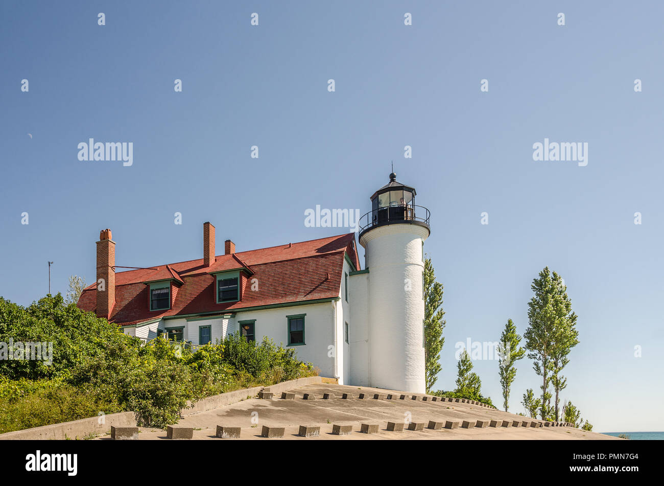 Point Betsie Lighthouse with its red roof and white building. The moon ...