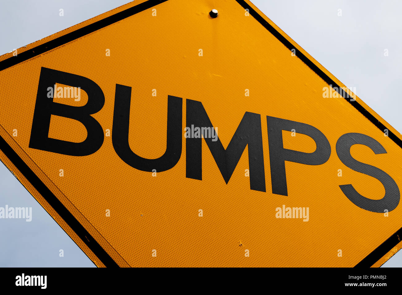 Abstract bumps road sign close up and a blue sky Stock Photo - Alamy