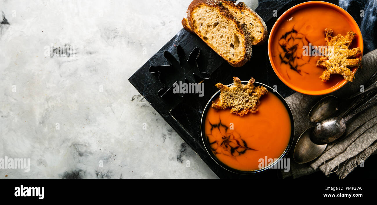 Halloween style pumpkin soup - with spider shaped toast Stock Photo - Alamy