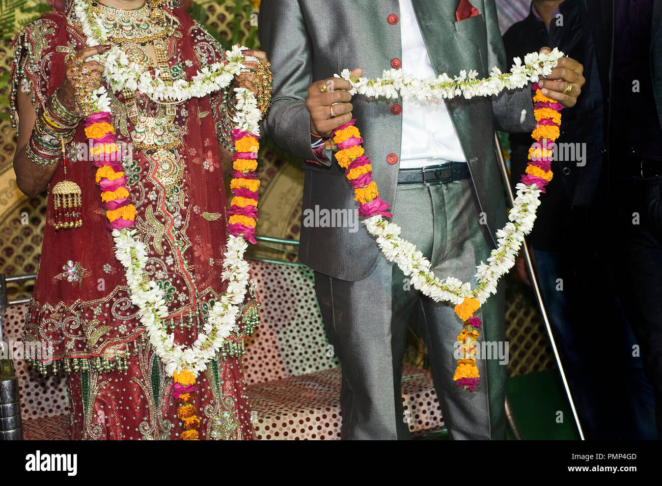 Indian bride and groom holding garlands during traditional Indian ...