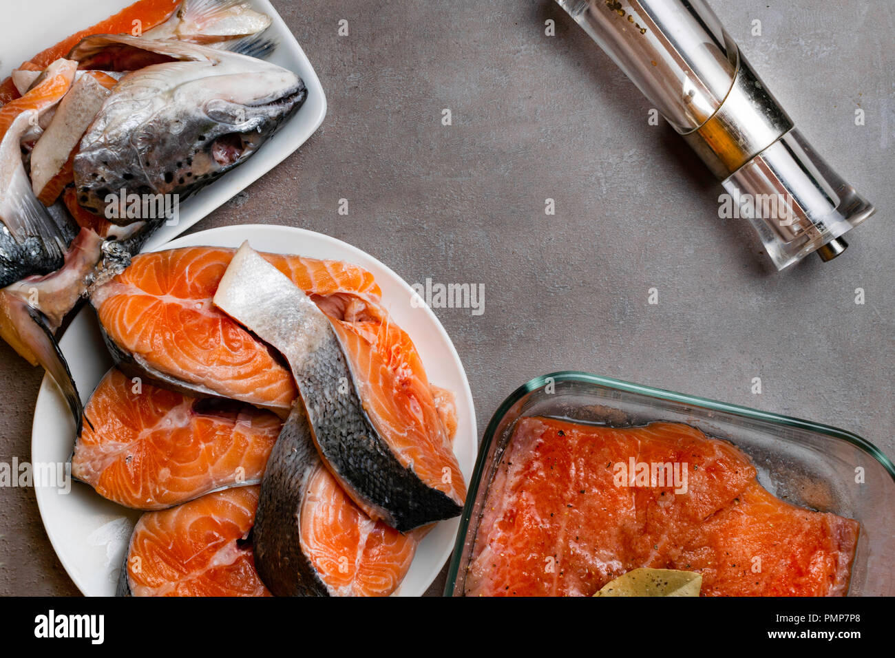 trout or salmon fish splitting on grey table, salted fillet, filler ...