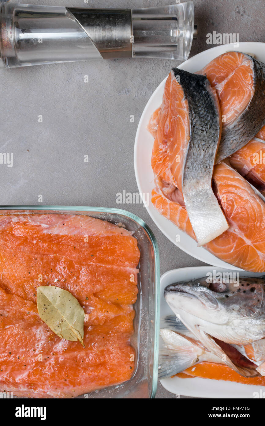 trout or salmon fish splitting on grey table, salted fillet, filler ...