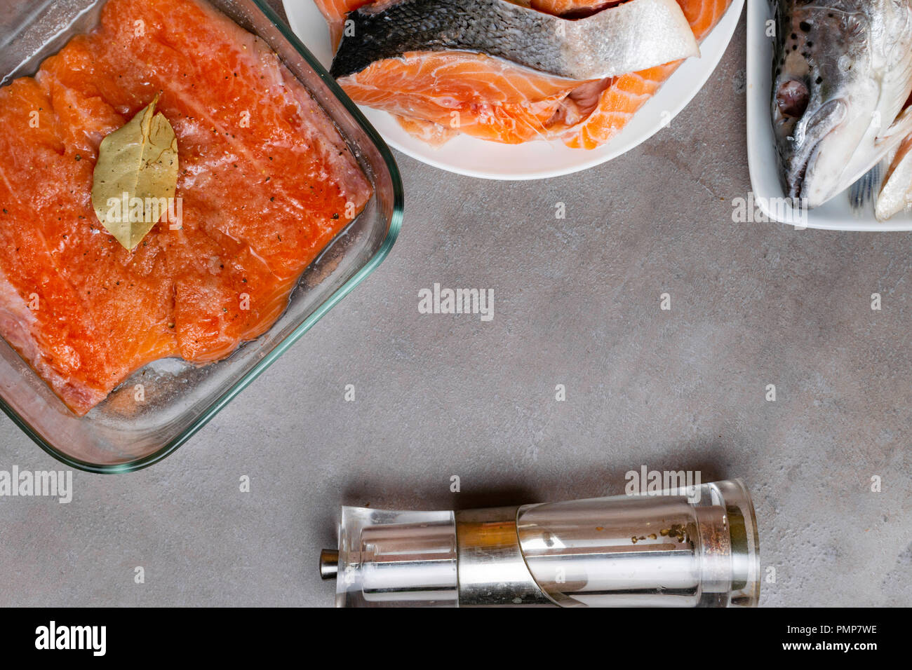 trout or salmon fish splitting on grey table, salted fillet, filler ...