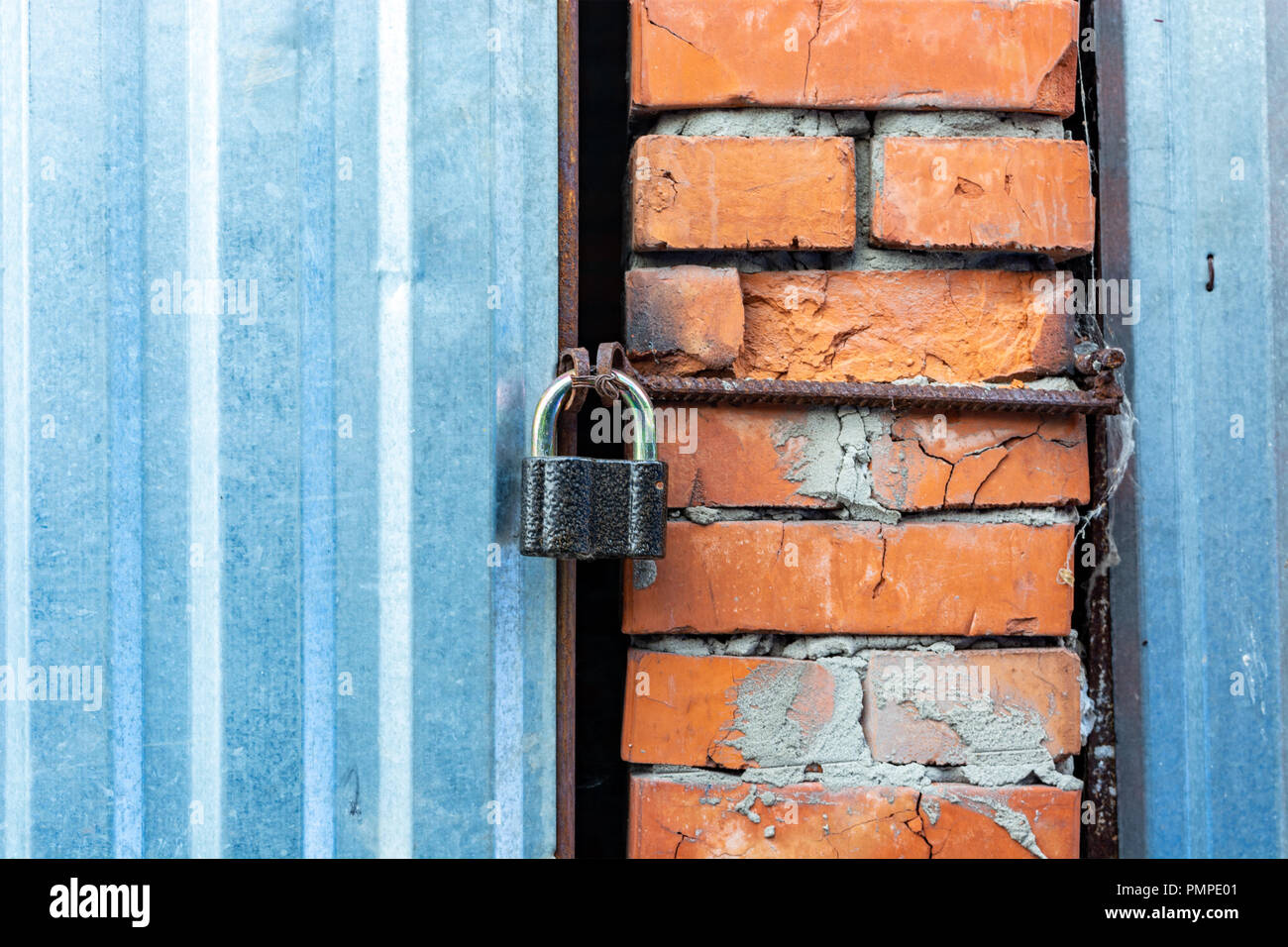 lock on the iron door wall brick in the day Stock Photo - Alamy