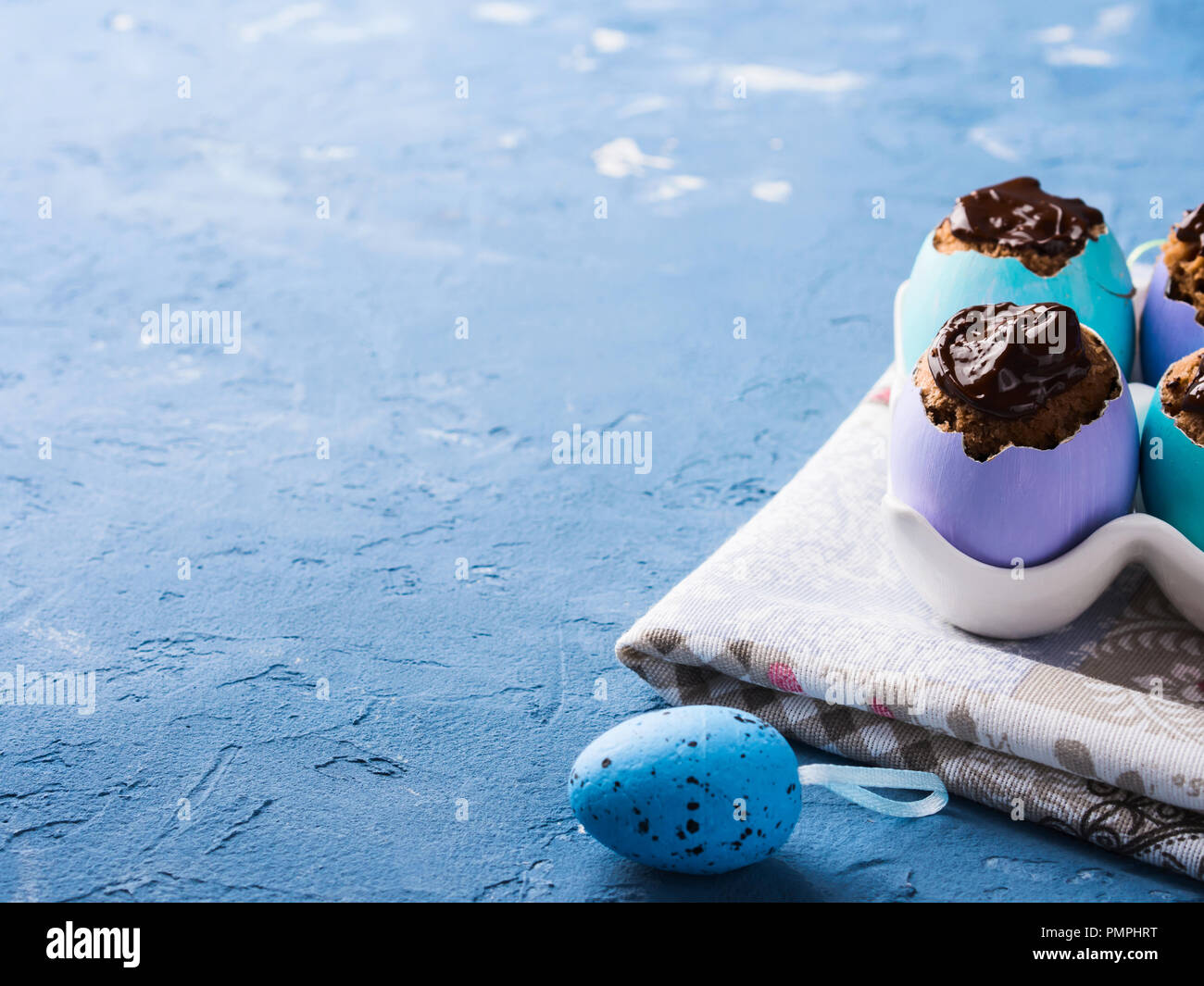 Easter blue background with cakes in colorful egg shells Stock Photo ...
