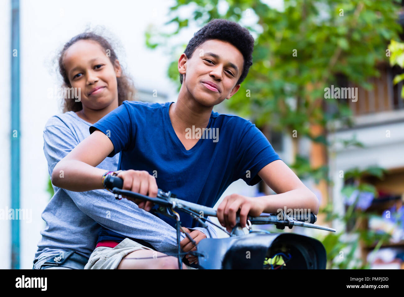 Hispanic teen riding bike hi-res stock photography and images - Alamy