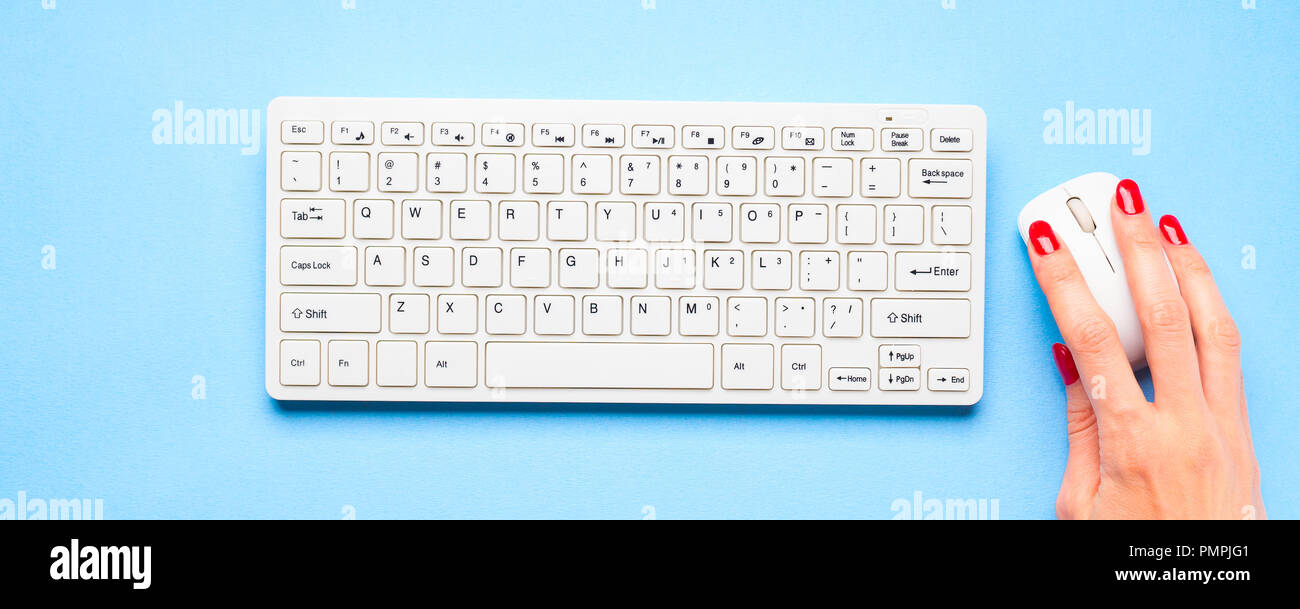 White keyboard and woman's hand on mouse. Blue minimal background Stock ...