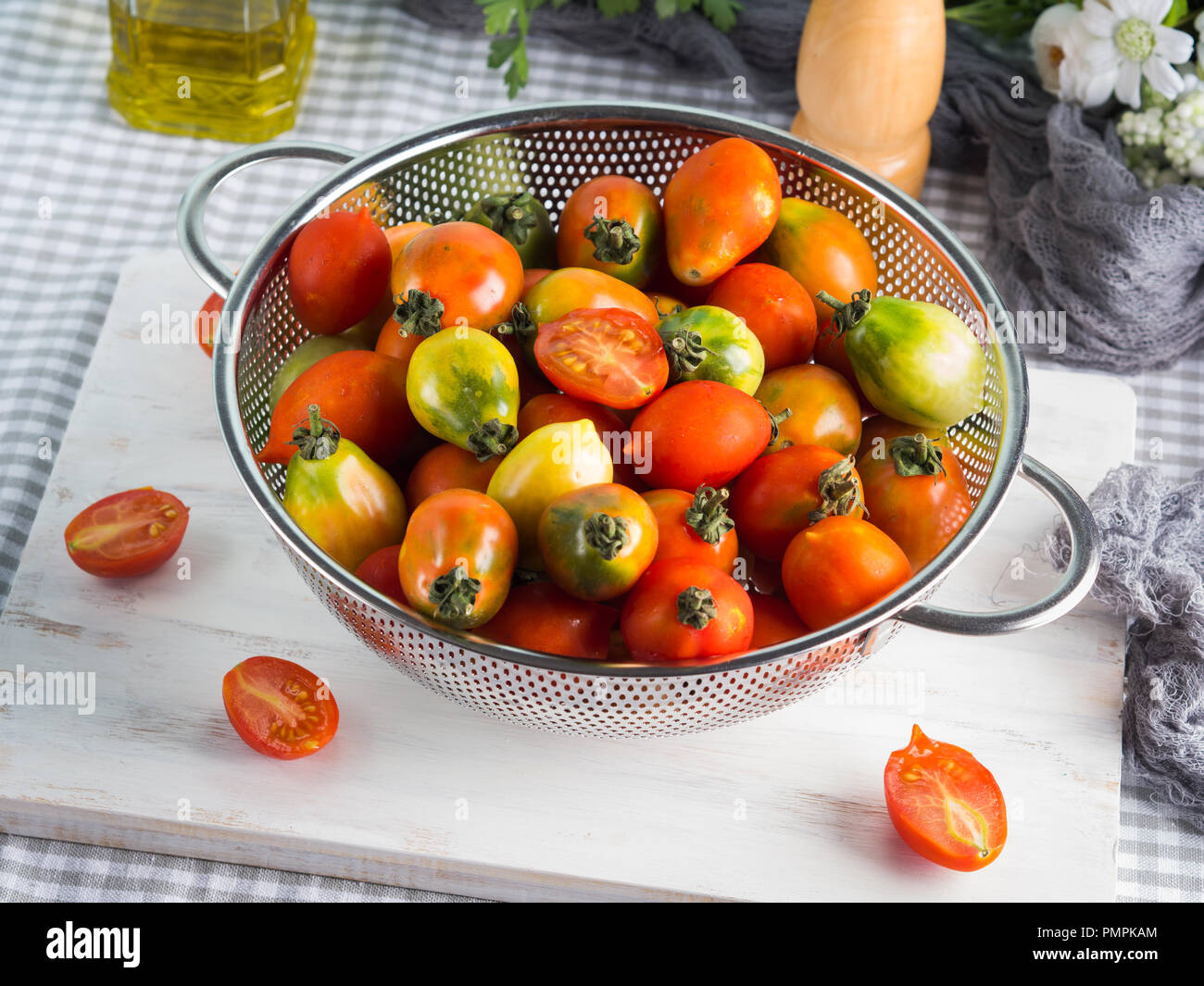 Italian tomatoes in a colander on table. Cooking with tomatoes concept ...