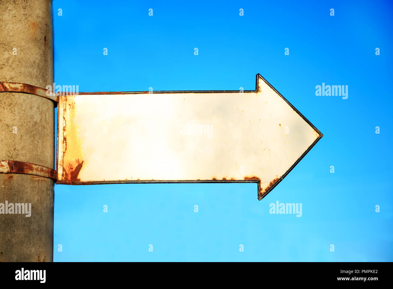 Column with signposts on blue sky background Stock Photo - Alamy