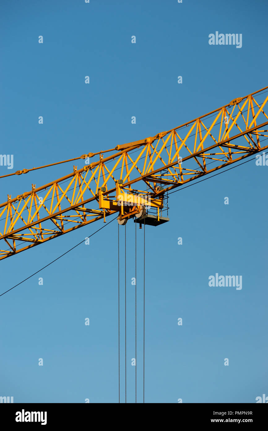 Details of a tower crane against the background of clear blue sky ...