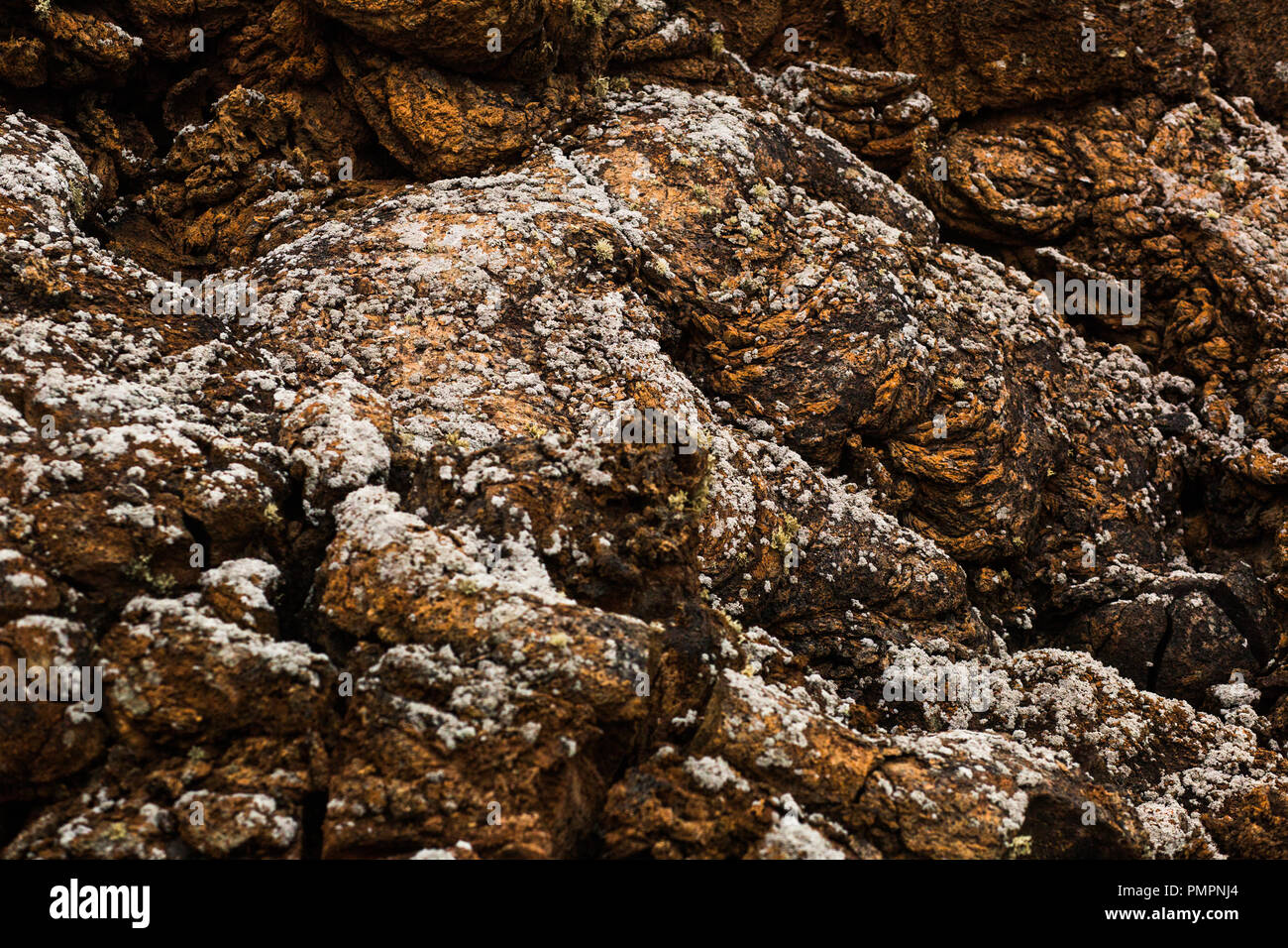 Layers of rocky lava flow from a volcanic eruption in lava fields on ...