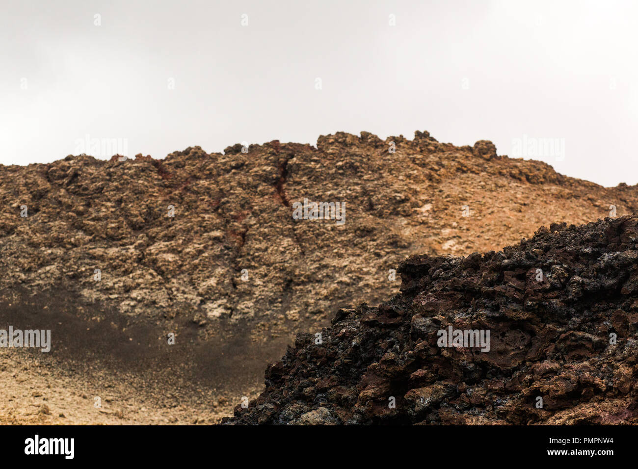 Layers of rocky lava flow from a volcanic eruption in lava fields on ...