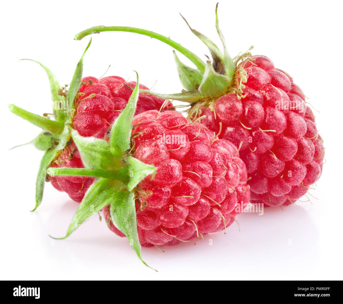 Red colored raspberries with two leaves isolated on white background ...