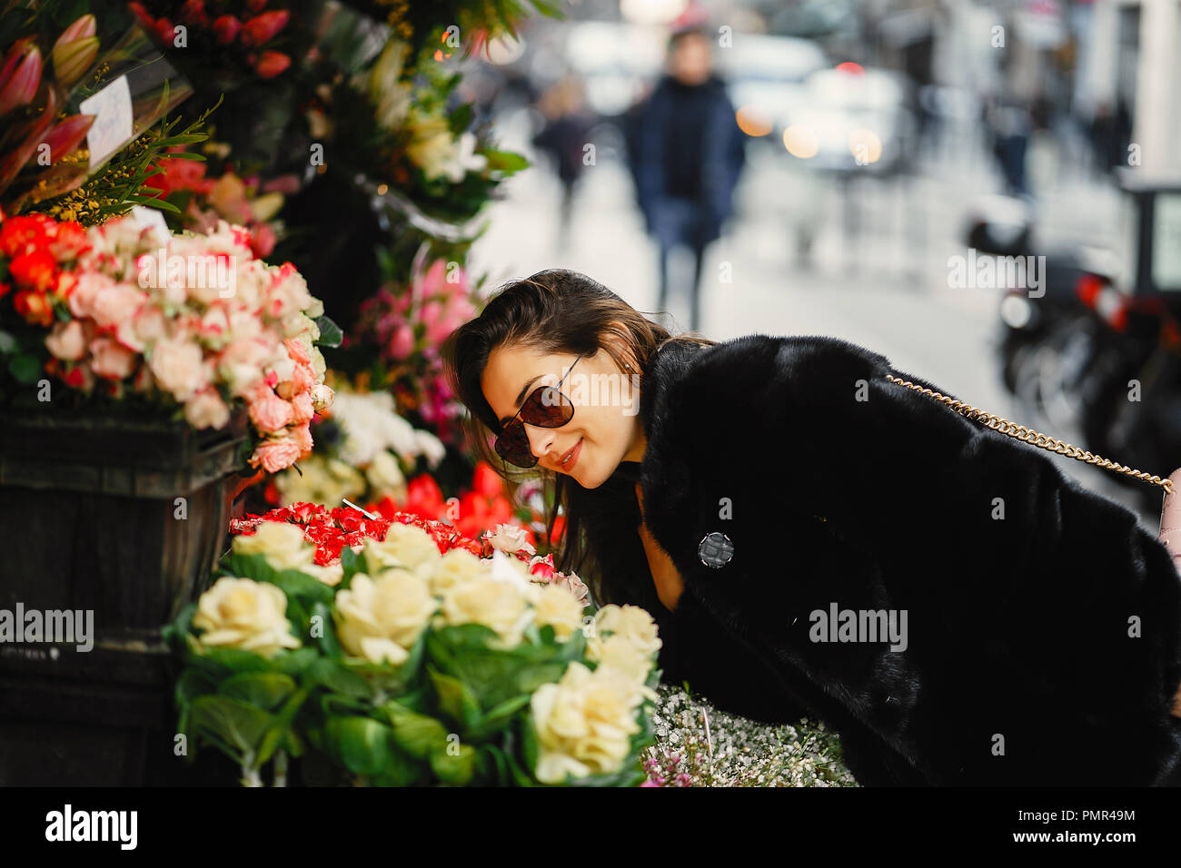 girl stopped to smell the flowers at a market in Paris Stock Photo - Alamy