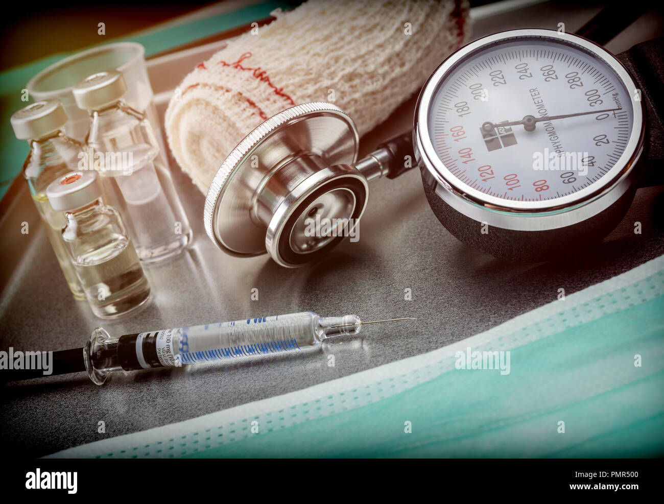 Vials next to a manometer to measure blood pressure and a stethoscope ...