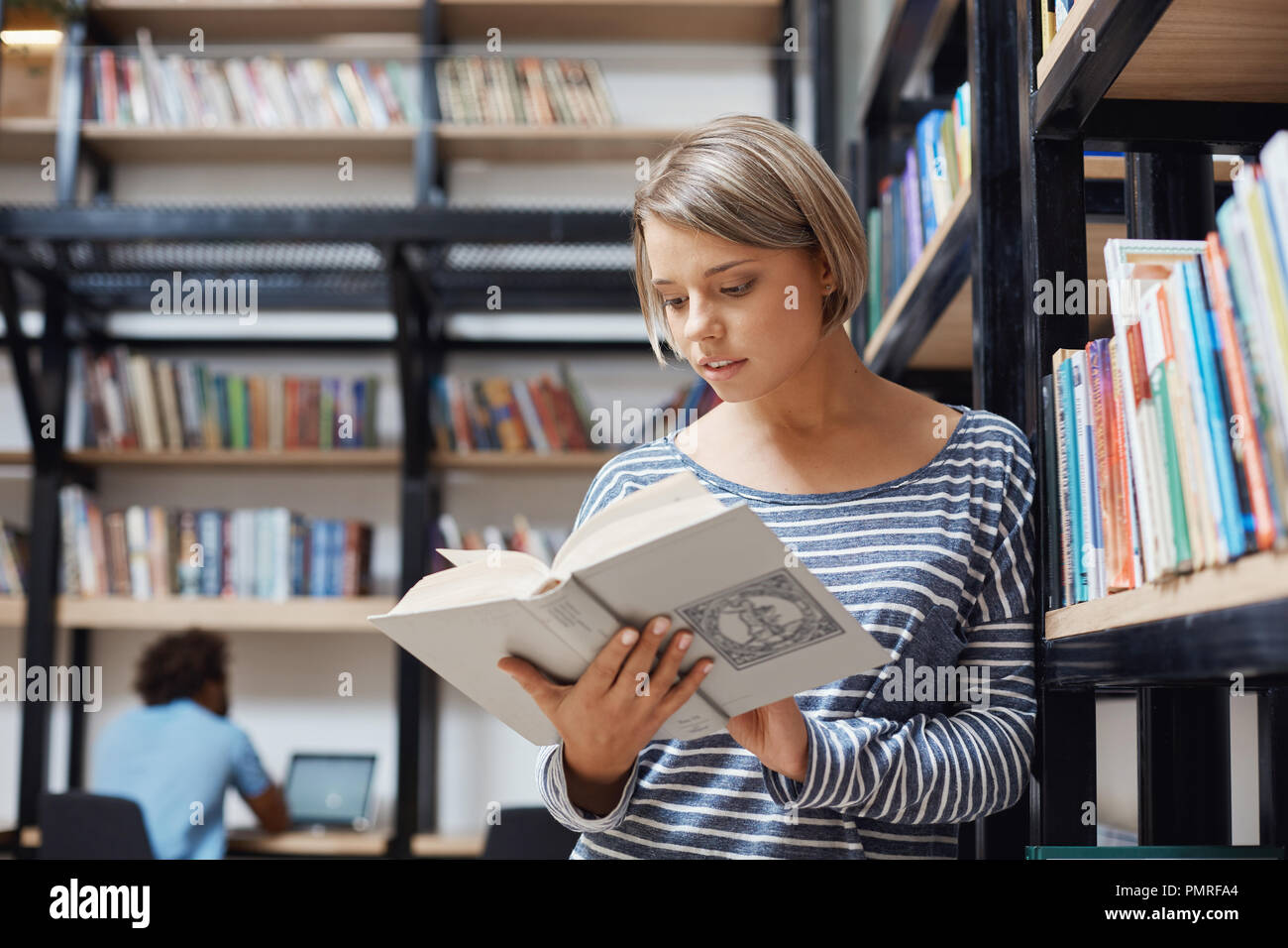 Portrait of charming blonde student girl with short hair in casual ...
