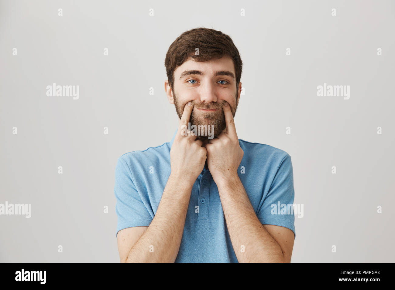 Gloomy guy with sad smile. Portrait of upset tired young bearded man ...