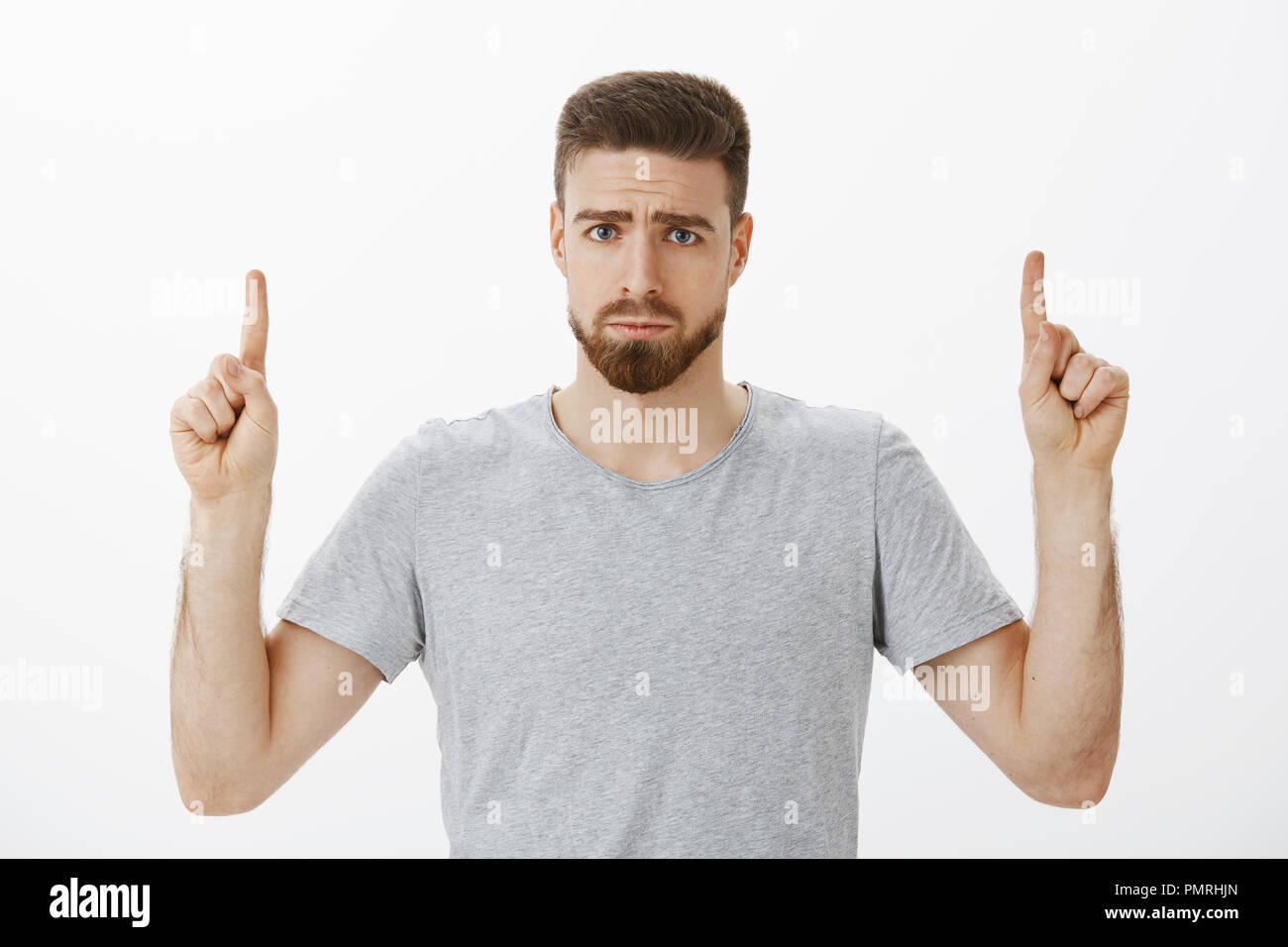 Portrait of unhappy sad and silly handsome male with beard and ...