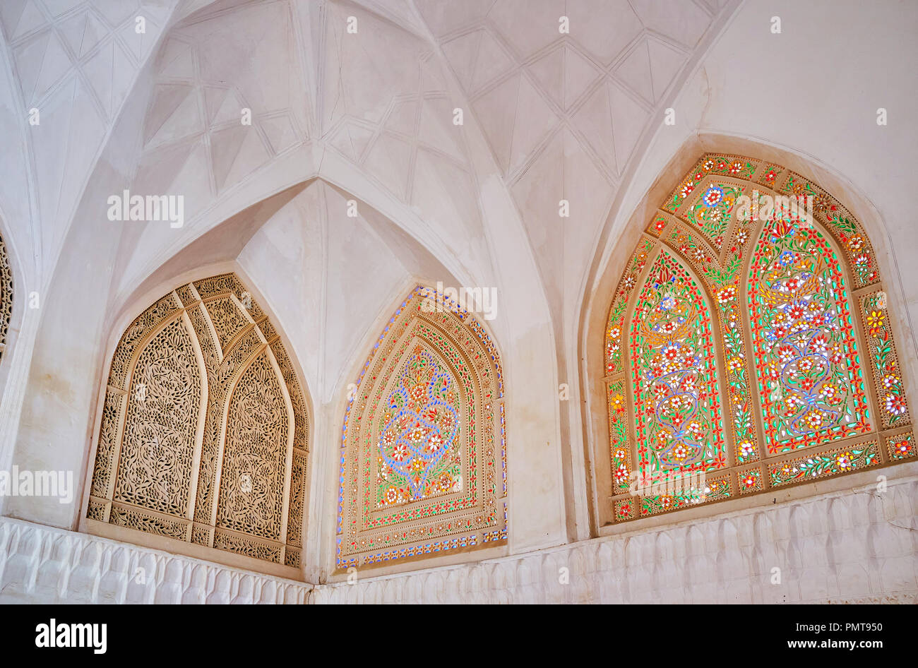 KASHAN, IRAN - OCTOBER 22, 2017: The arched stained-glass windows with ...