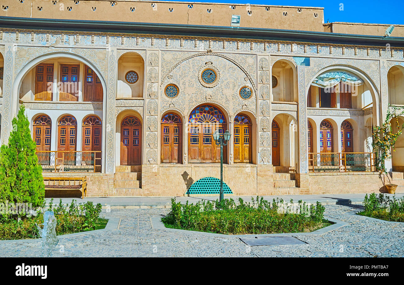 KASHAN, IRAN - OCTOBER 22, 2017: The scenic courtyard of Tabatabaei House with flower beds ...