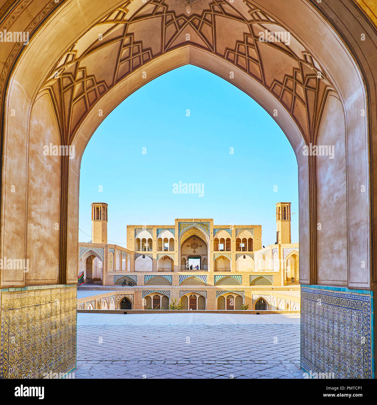 The richly decorated portal (iwan) of Agha Bozorg Mosque through the ...